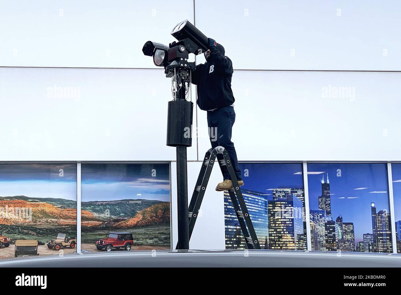 A maintenance worker is seen removing the recording mechanism from a ...