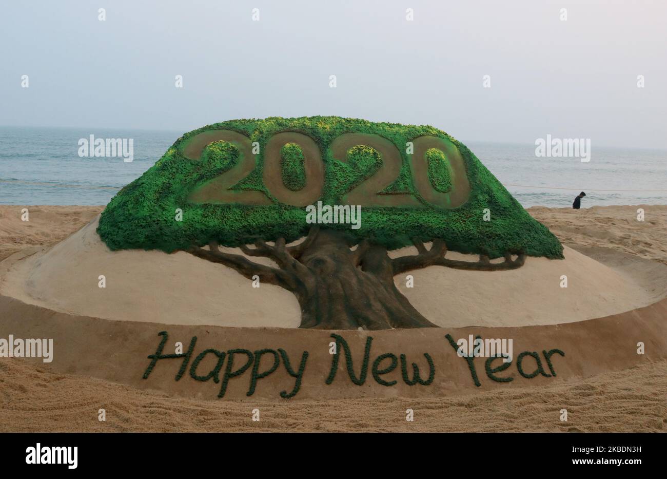 A new year 2020 sand sculpture is seen at the Bay of Bengal Sea's ...