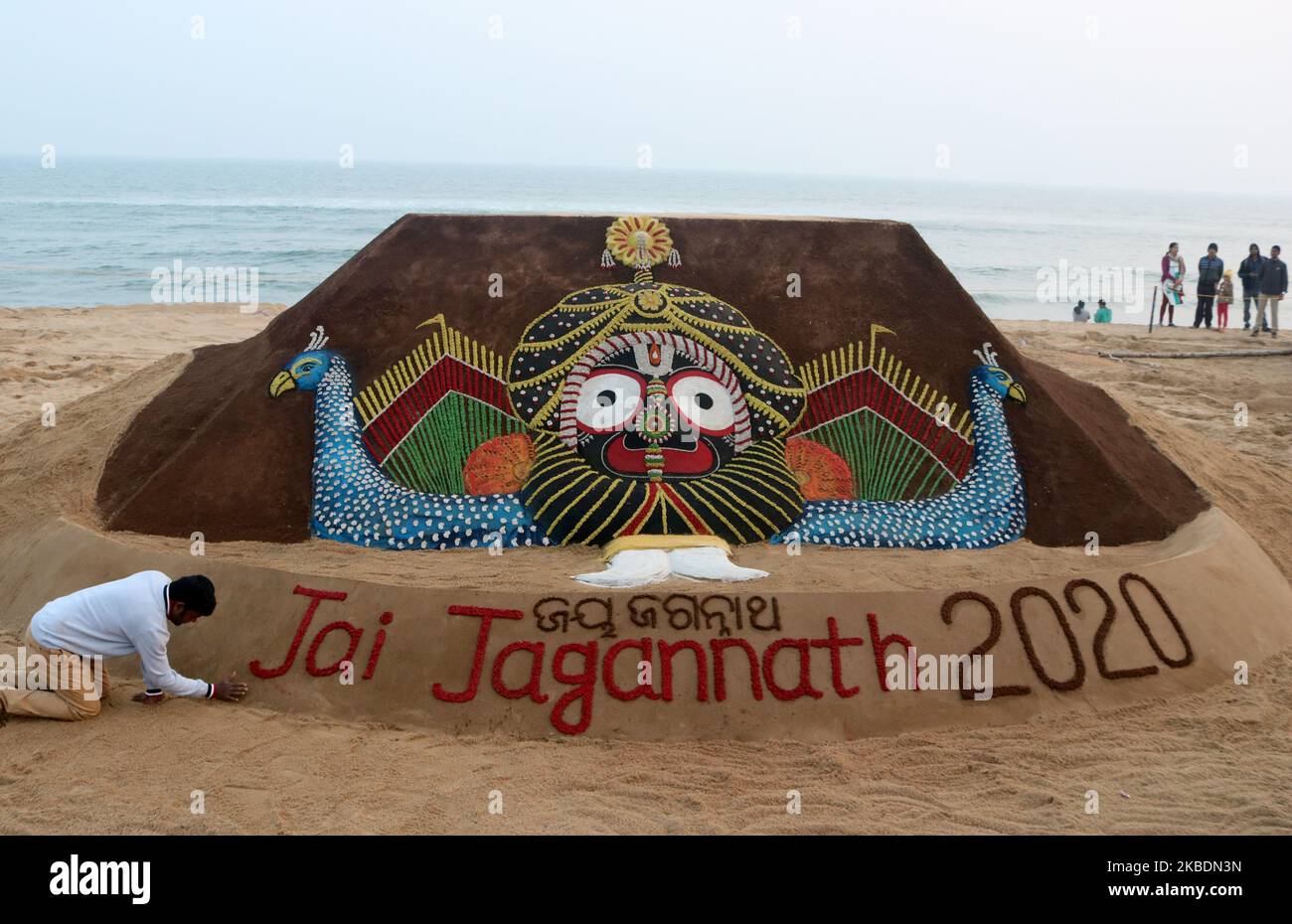A new year 2020 sand sculpture is seen at the Bay of Bengal Sea's ...
