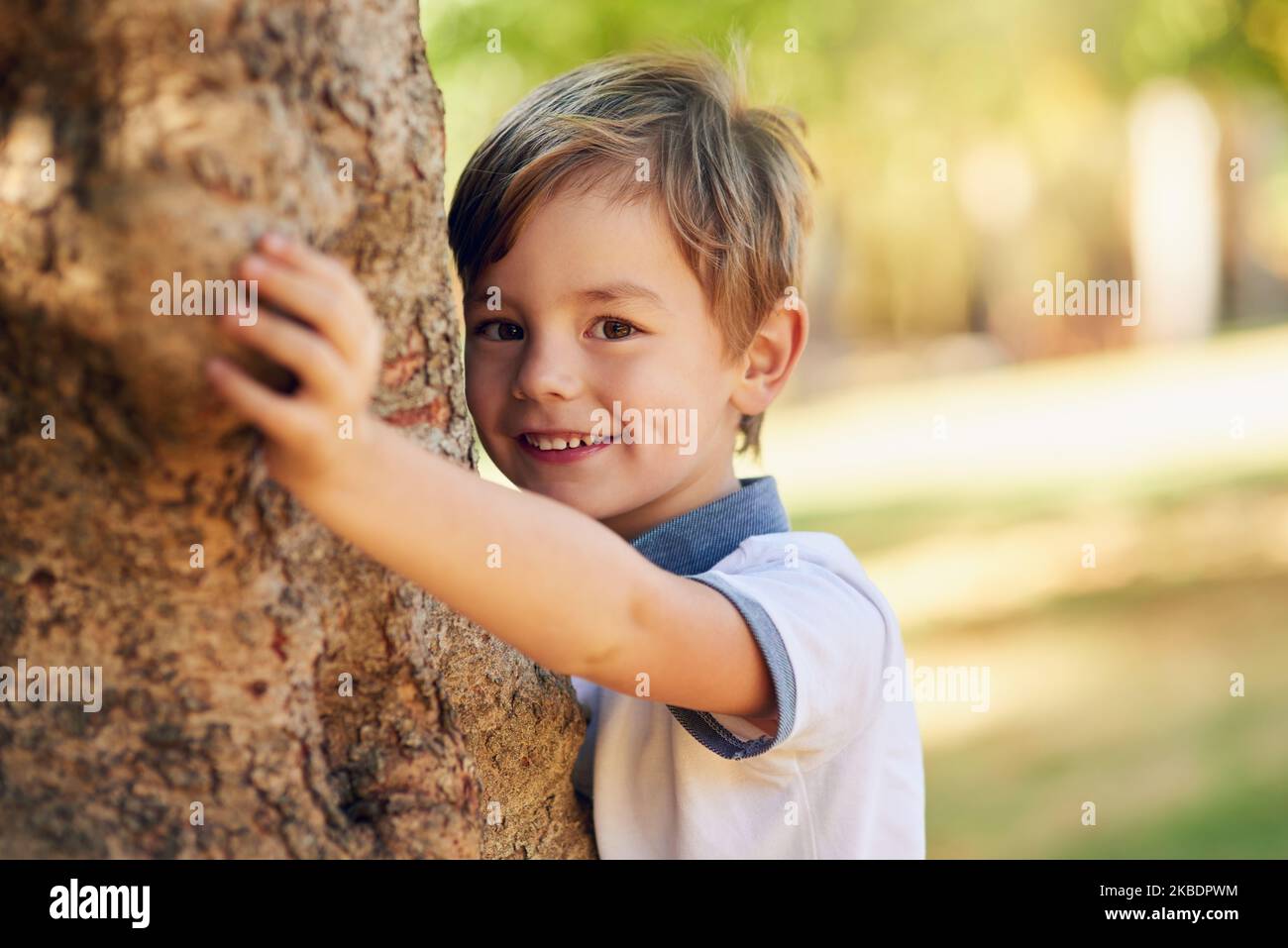 Boy hugging tree hi-res stock photography and images - Alamy