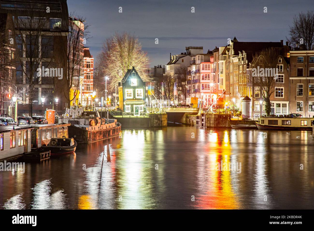 Canals in Amsterdam like Amstel with typical traditional old dutch architecture houses ...