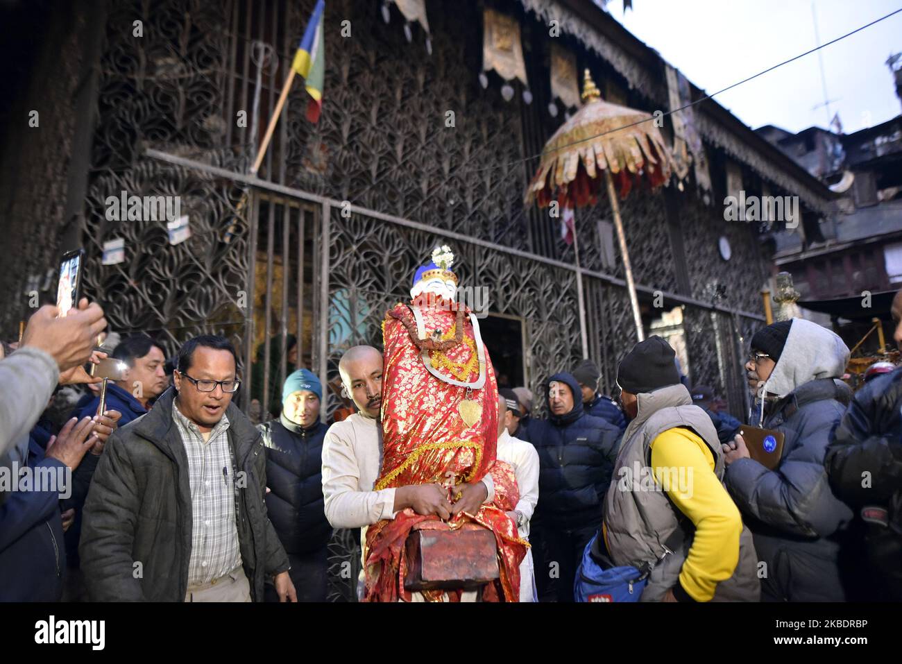A Nepalese Priest carrying Lord Seto Machhendranath for a annual ritual ...