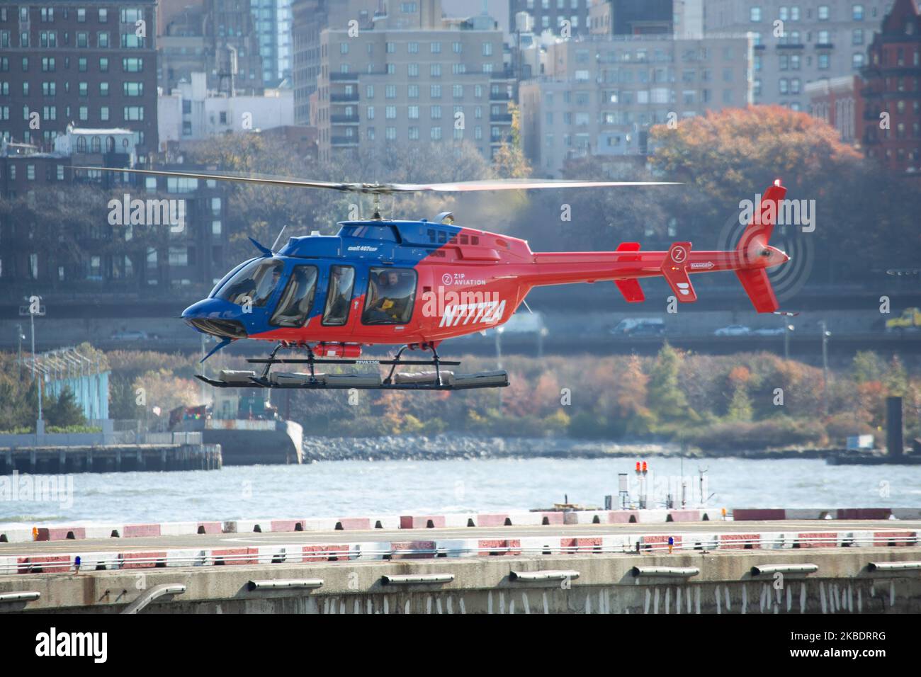 A red-blue helicopter Bell 407GXP with registration N777ZA of Zip ...