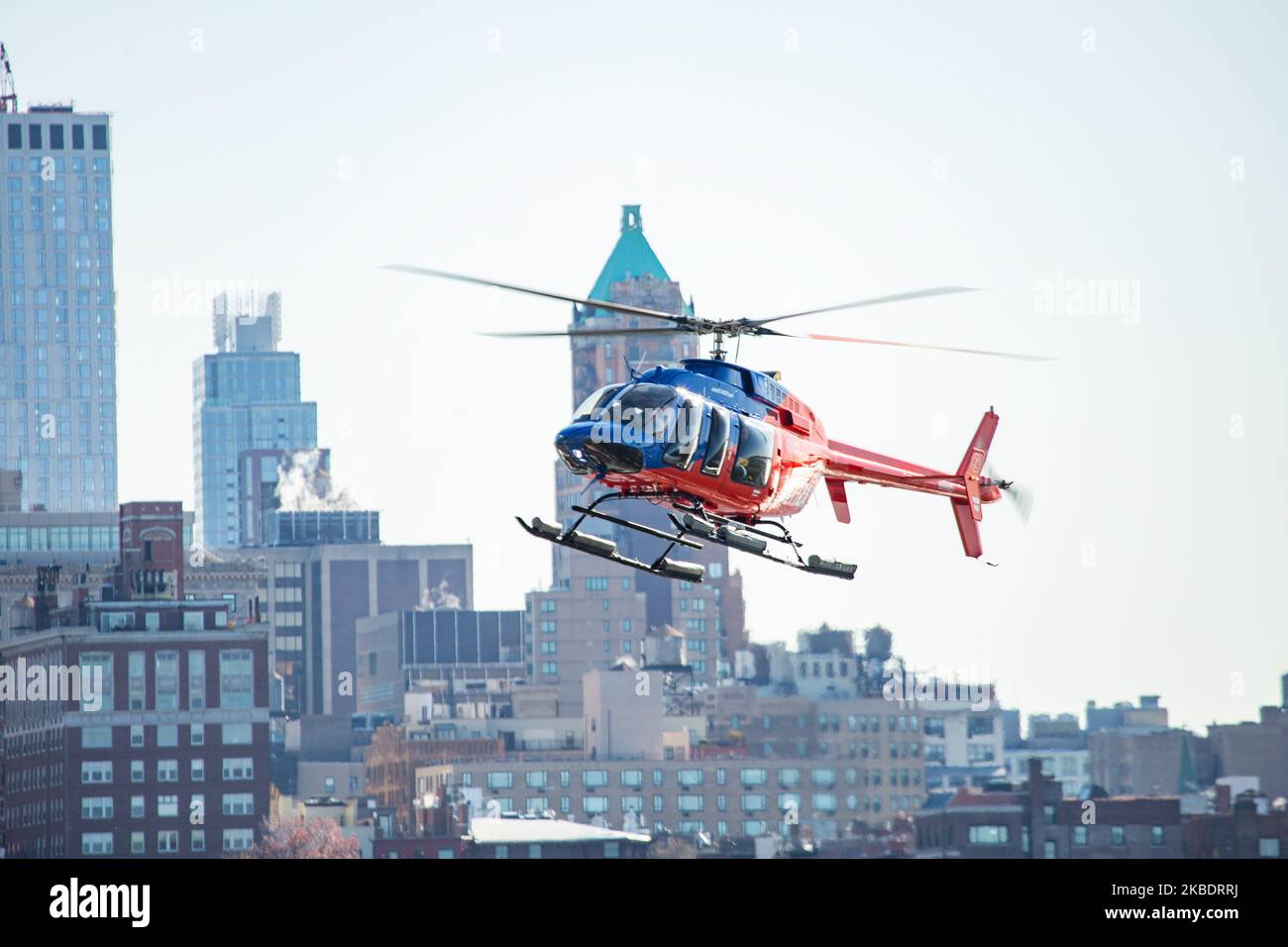 A red-blue helicopter Bell 407GXP with registration N777ZA of Zip ...