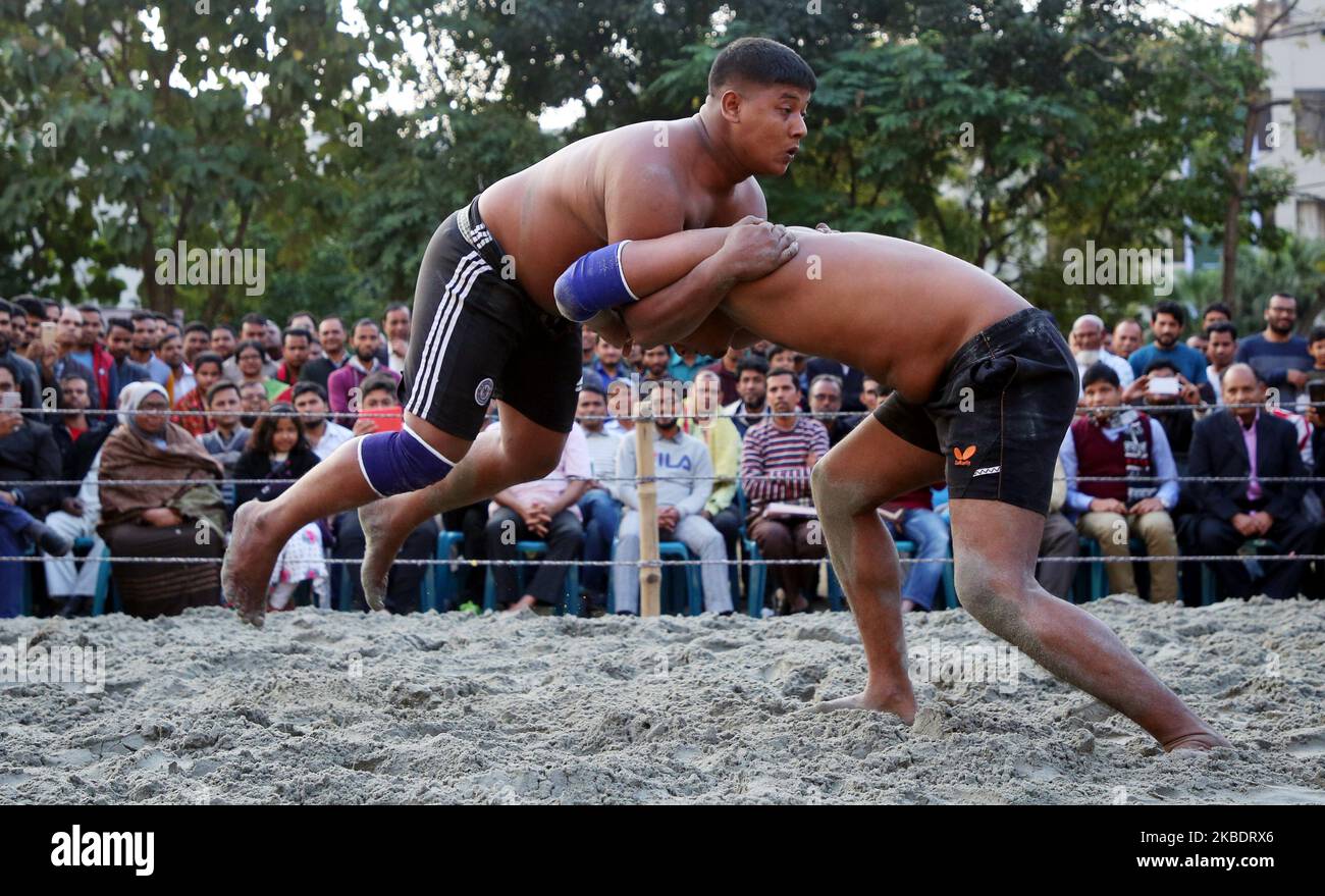 Wrestlers lock horns during a match of traditional Jabbarer Boli Khela ...