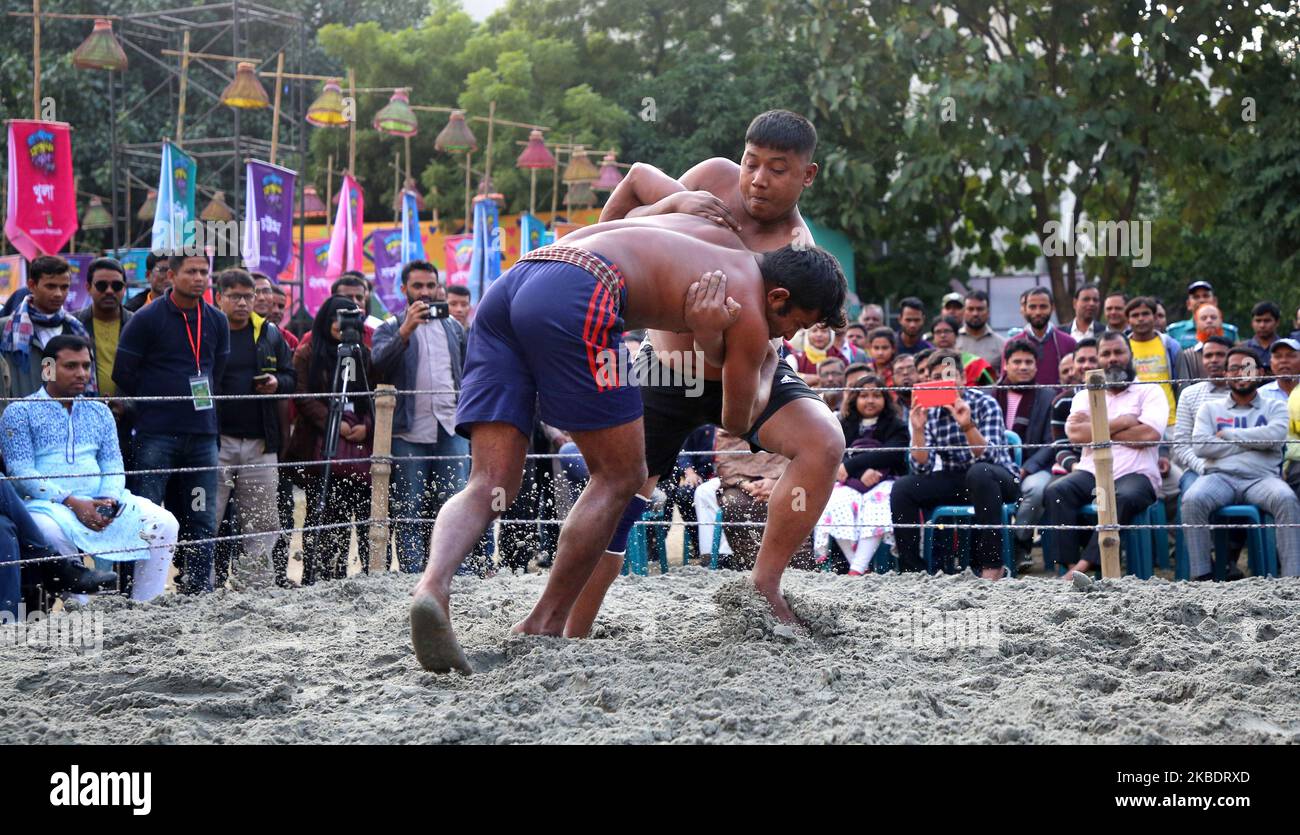 Wrestlers lock horns during a match of traditional Jabbarer Boli Khela ...