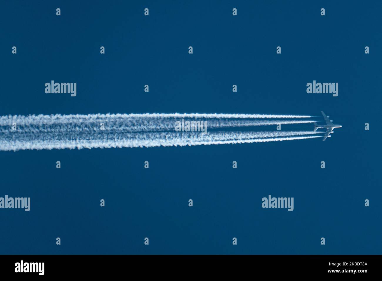 An airline commercial aircraft overflying in the blue sky long ...