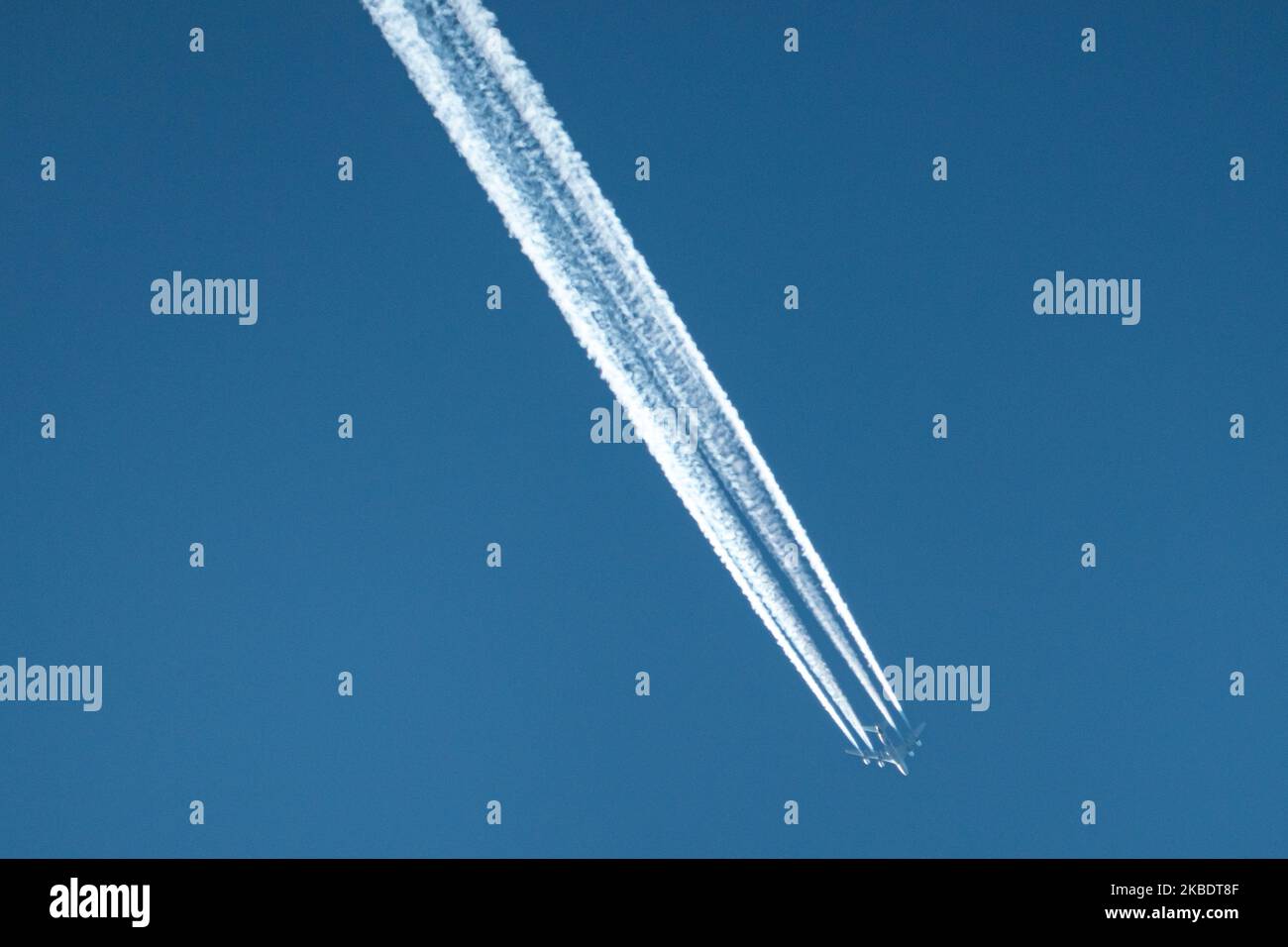 An airline commercial aircraft overflying in the blue sky long ...