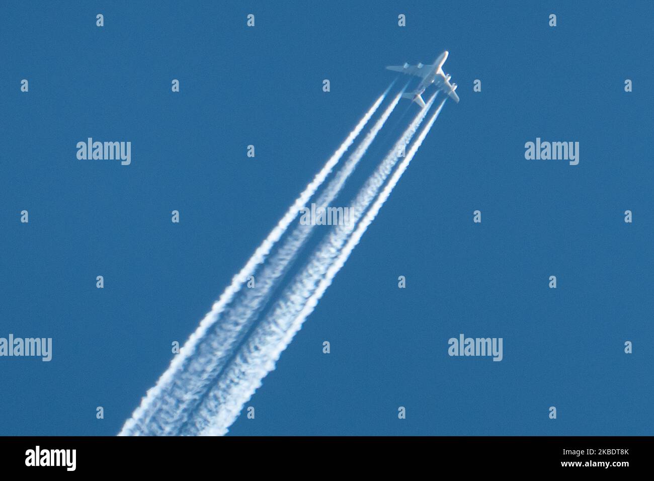 An airline commercial aircraft overflying in the blue sky long ...