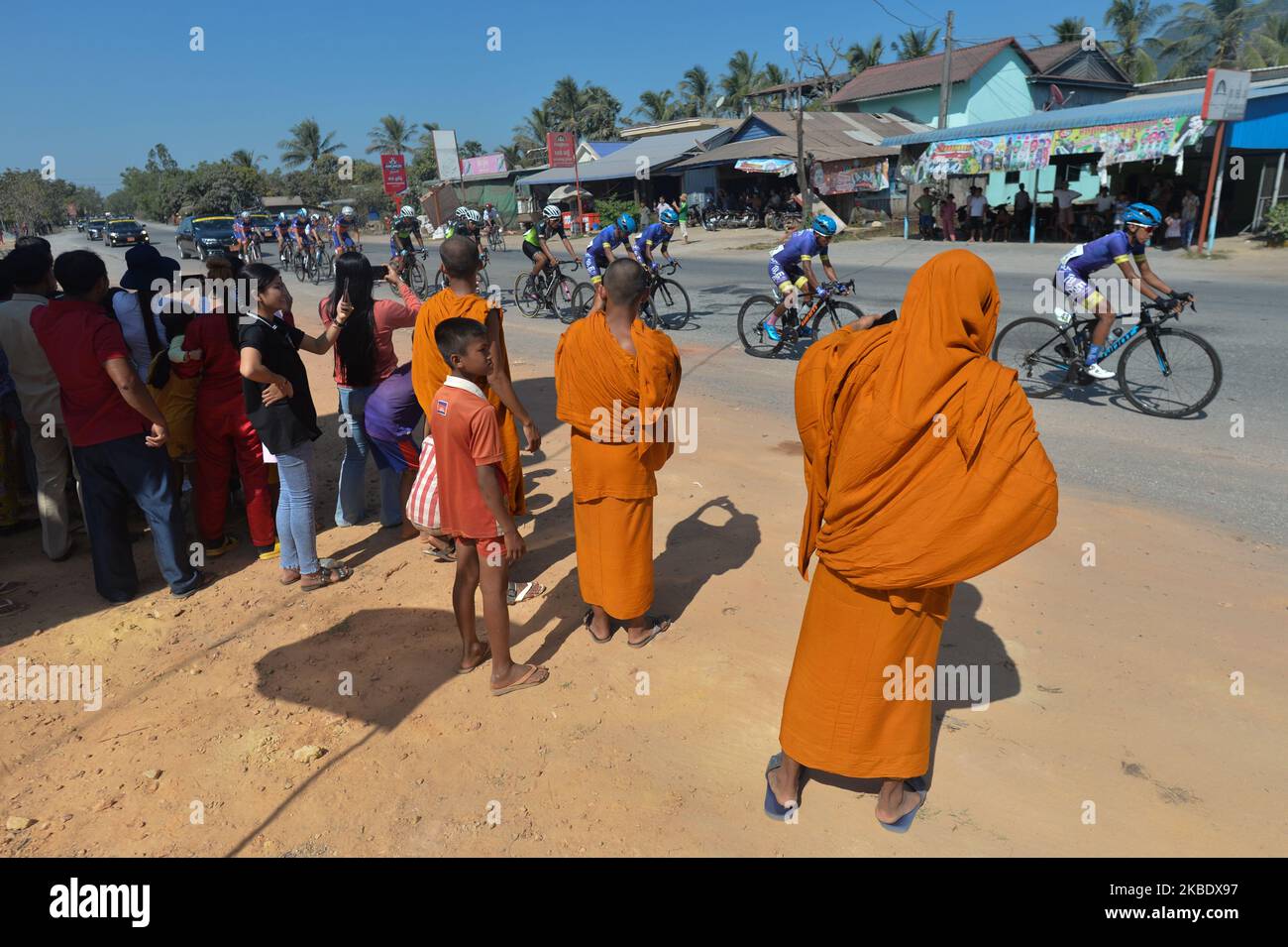Local buddhist monks watch riders in action during the second stage of ...