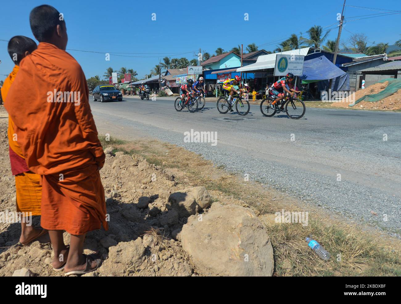 Local buddhist monks watch riders in action during the second stage of ...