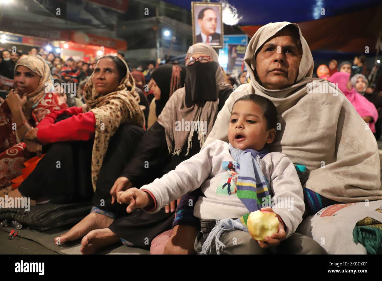 A woman holds a baby as they take part in the protests against the ...