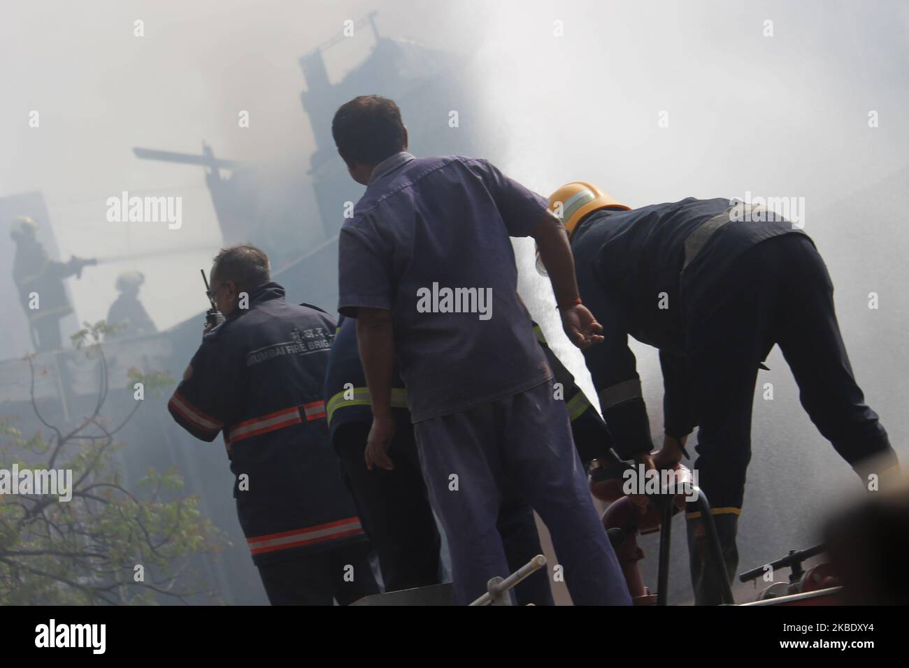 Firemen try to extinguish a fire that broke out in a building at ...