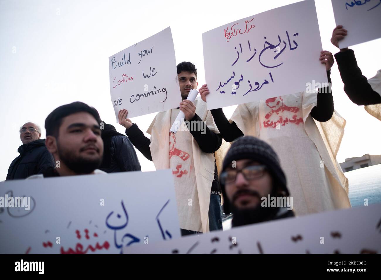 Iranian University students hold anti-U.S. placards during a mass ...