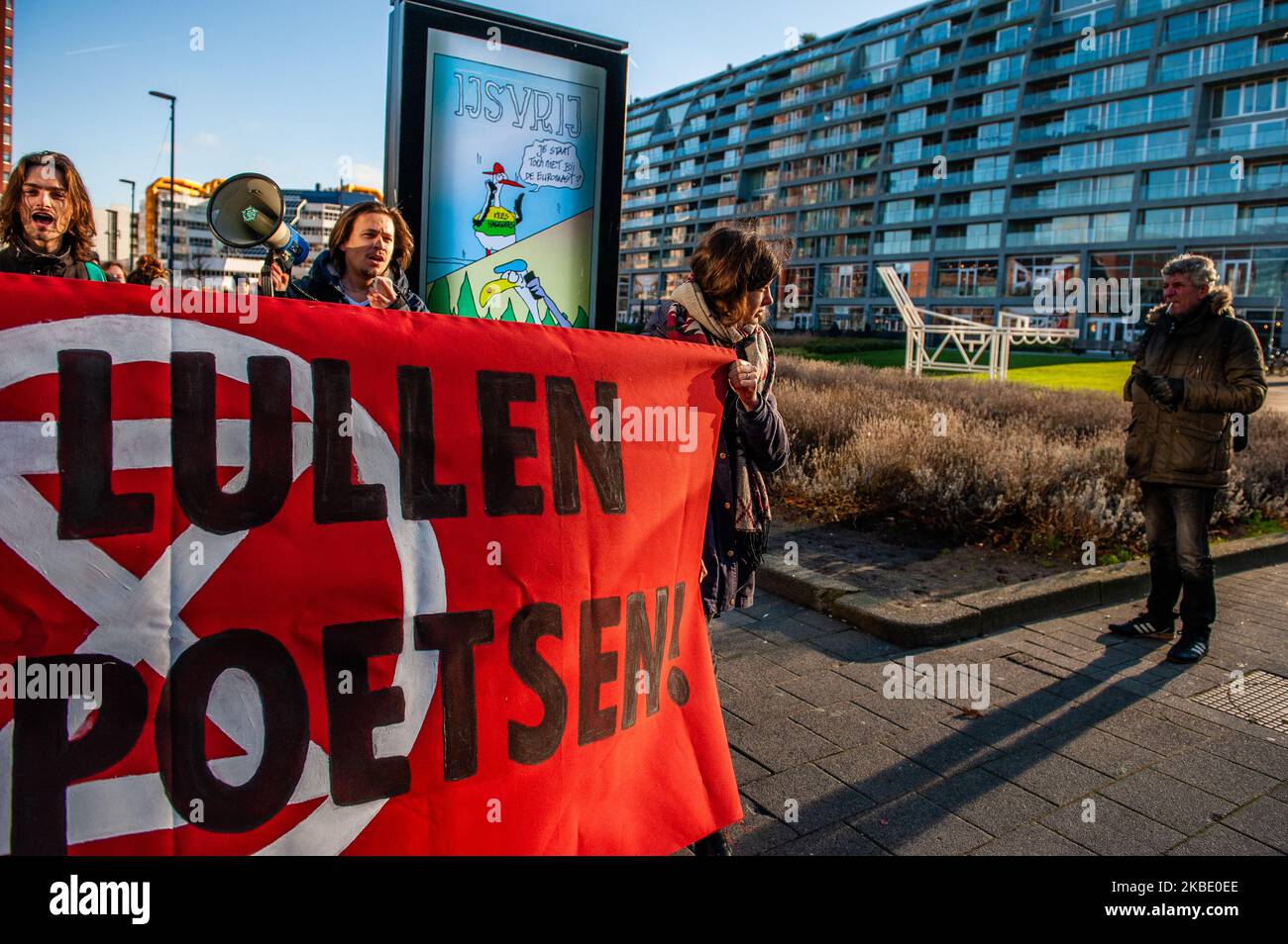 XR activists are walking while holding a big banner and shouting ...