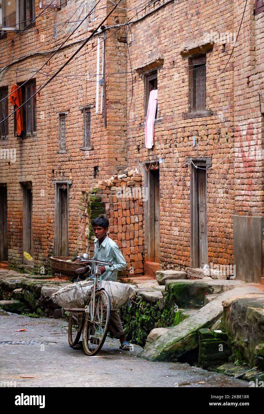A young man uses a bicycle to transport goods in Kathmandu, Nepal ...
