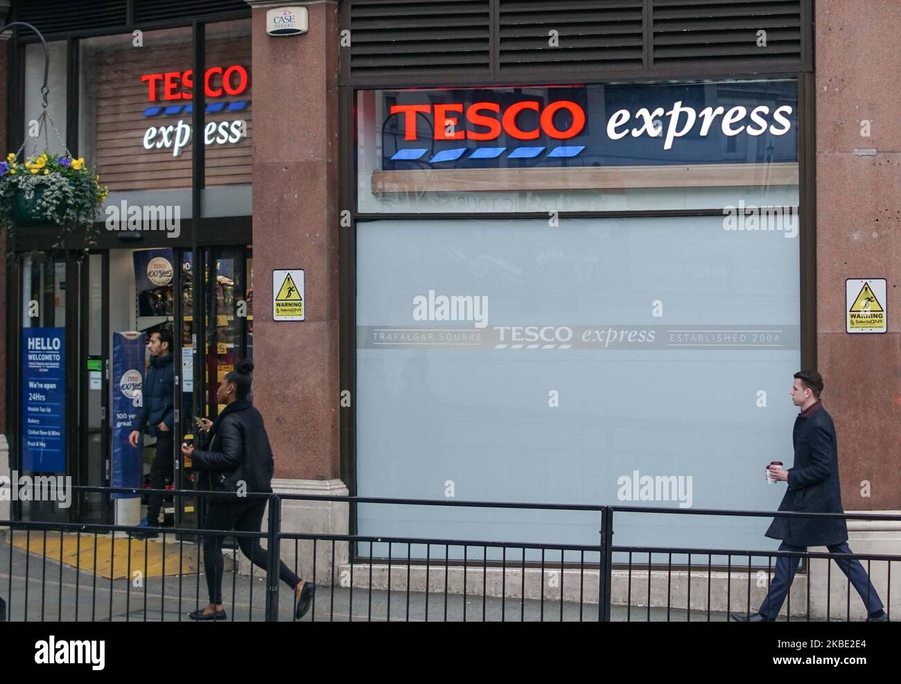 Members of public walk past Tesco supermarket in Westminster , in ...