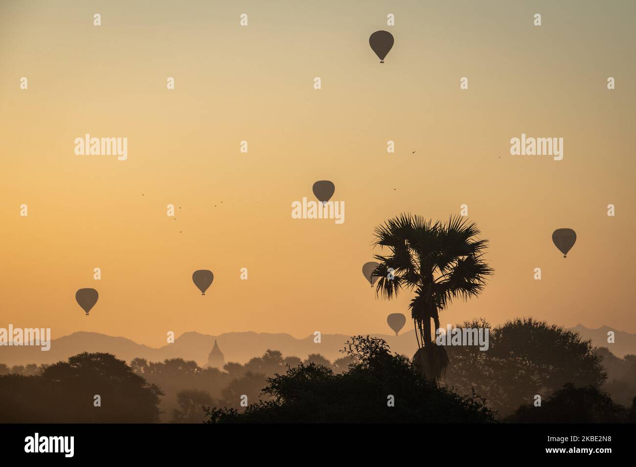 Hot air balloons fly over Bagan during sunrise in Bagan, Myanmar on ...