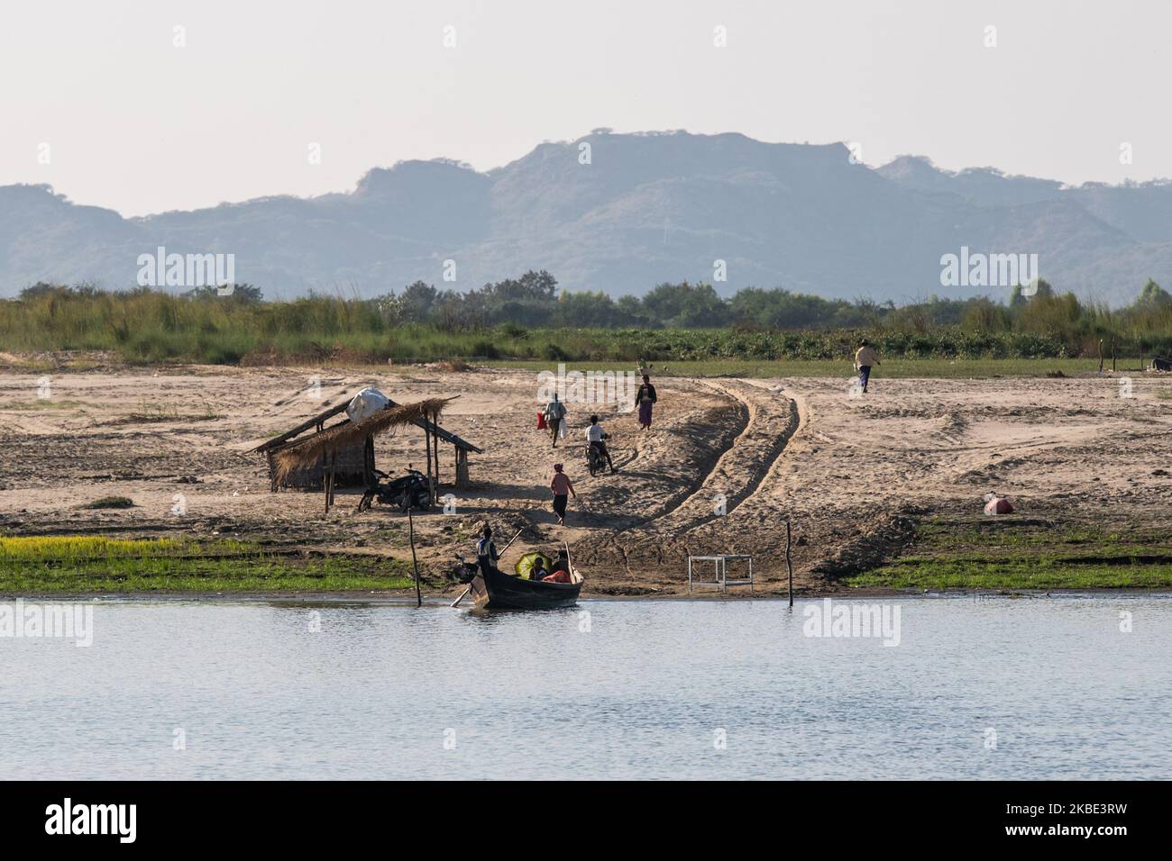 People use a boat to cross the Ayeyarwaddy river in Bagan, Myanmar on ...
