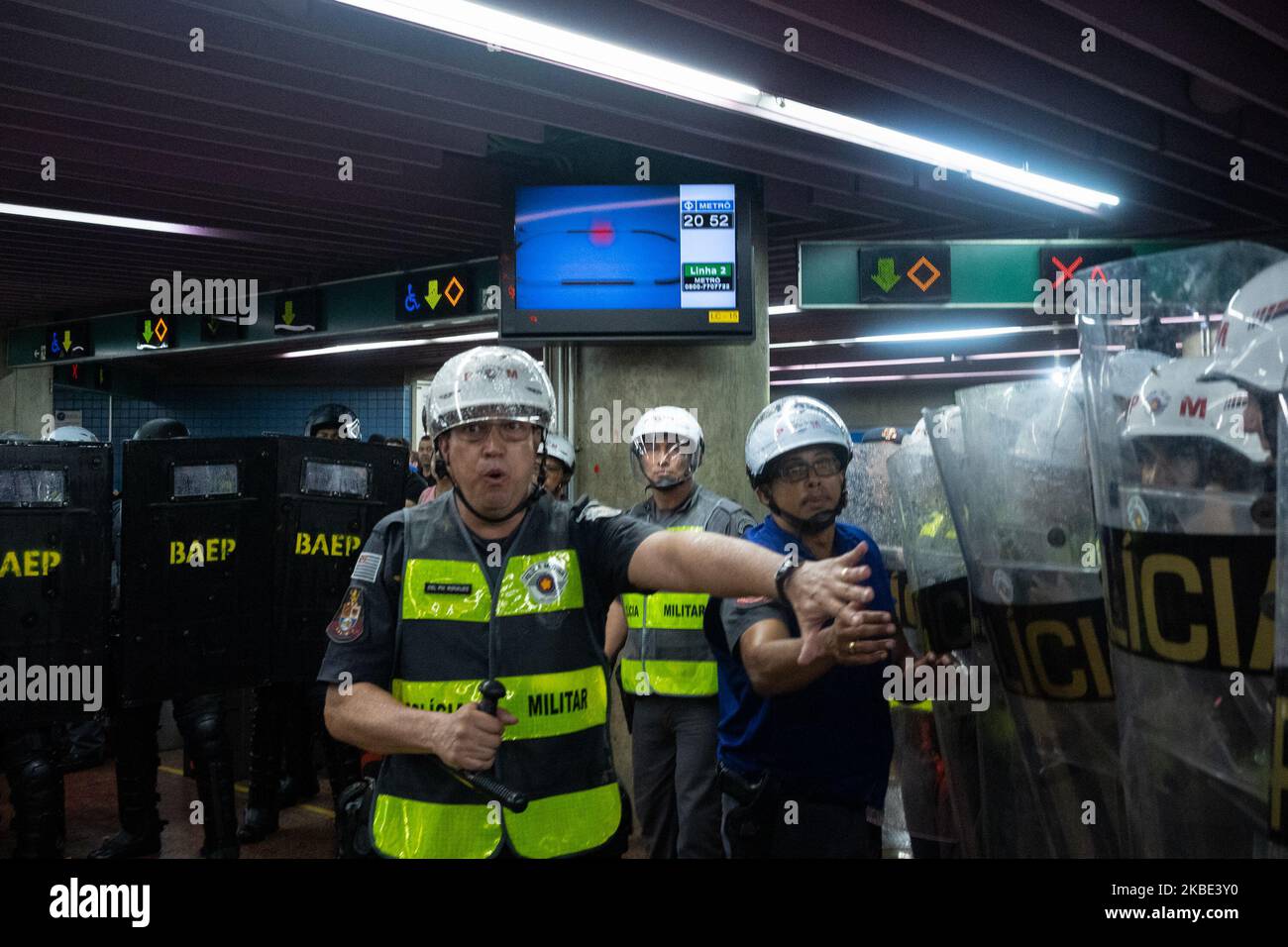 Police officers blocking protesters from crossing the turnstiles at the ...