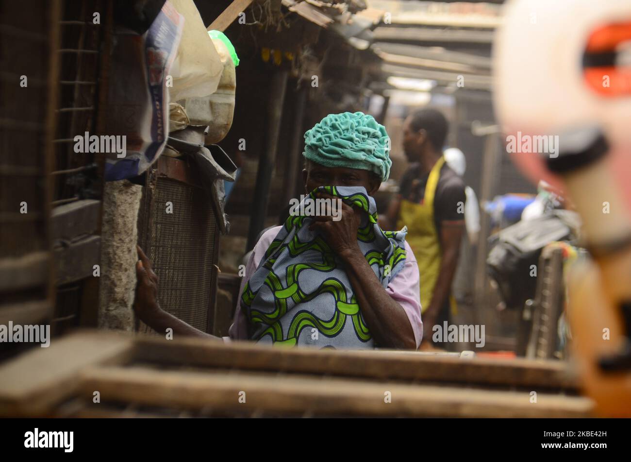 A market woman cover her nose with her rapper for protection during the ...