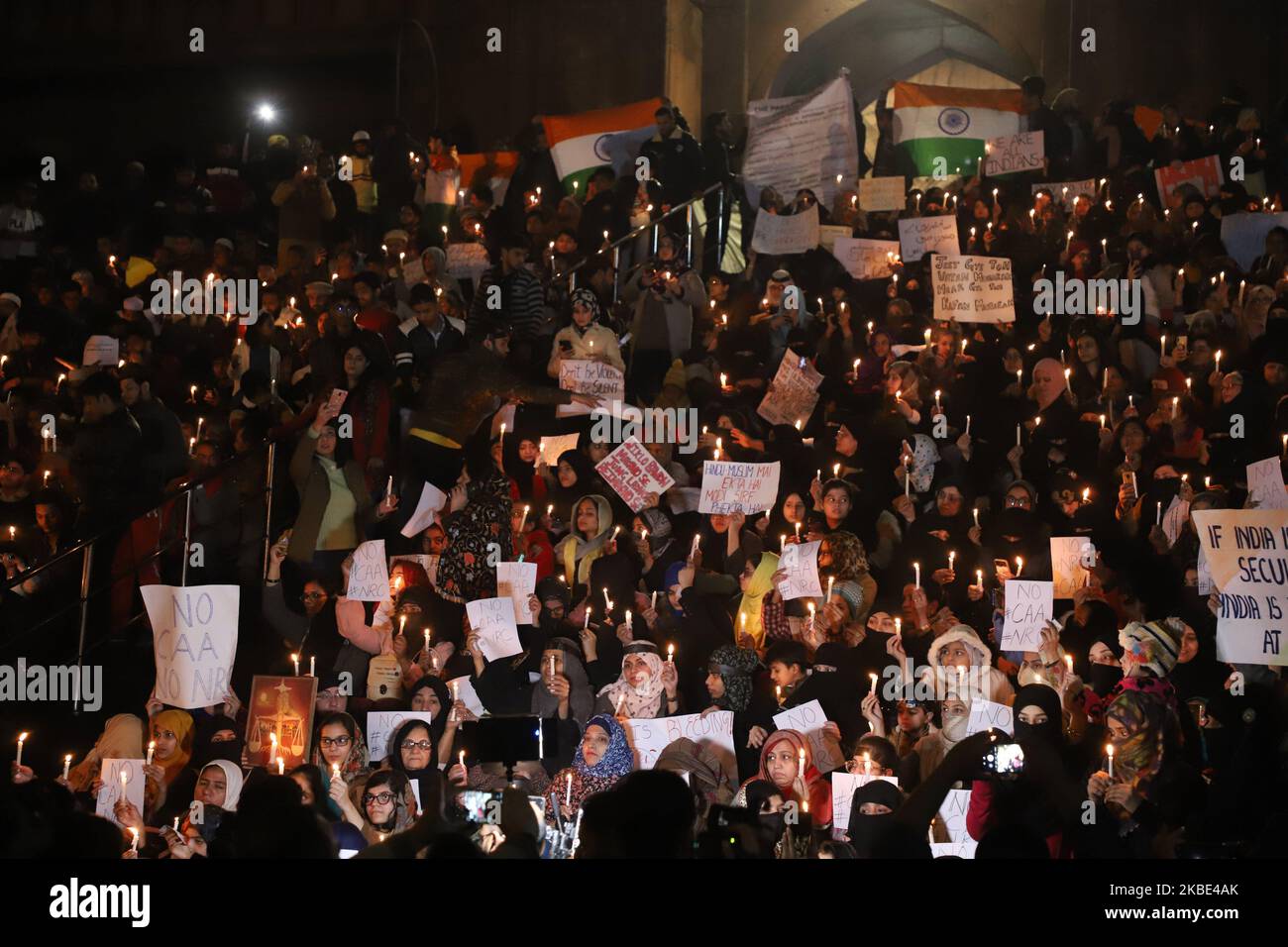 People take part in a candle light protest against the Citizenship ...