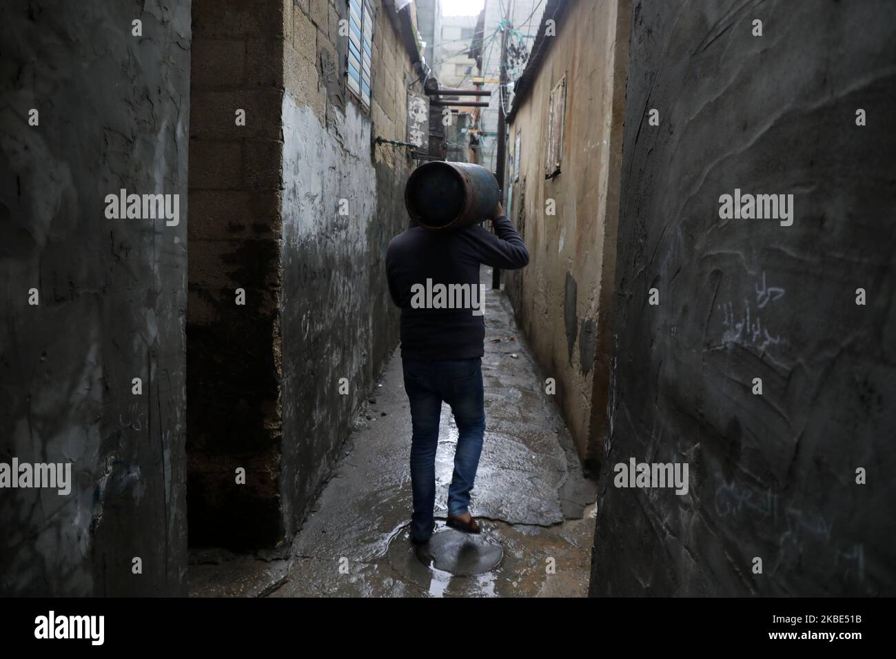 A Palestinian refugee holds a gas cylinder at astreet at al-Shati ...