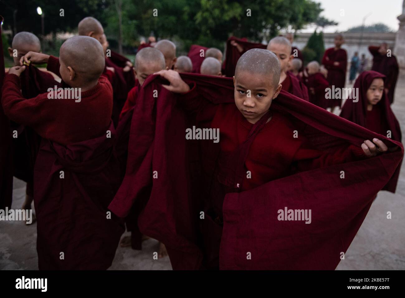 Buddhist novice monk prepares his robe before lining up during Ananda ...
