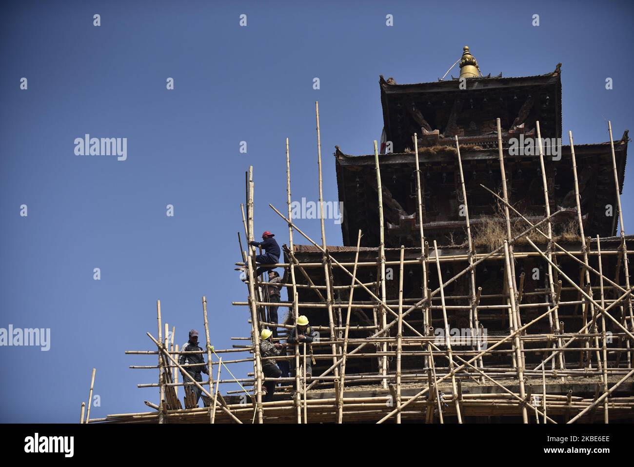 Nepalese workers renovating Nyatapola, the five-storey temple, which is ...