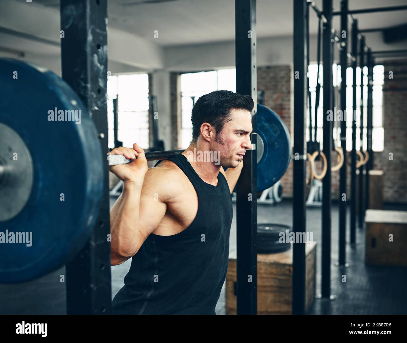 I look good in muscles. a man lifting weights at the gym Stock Photo ...