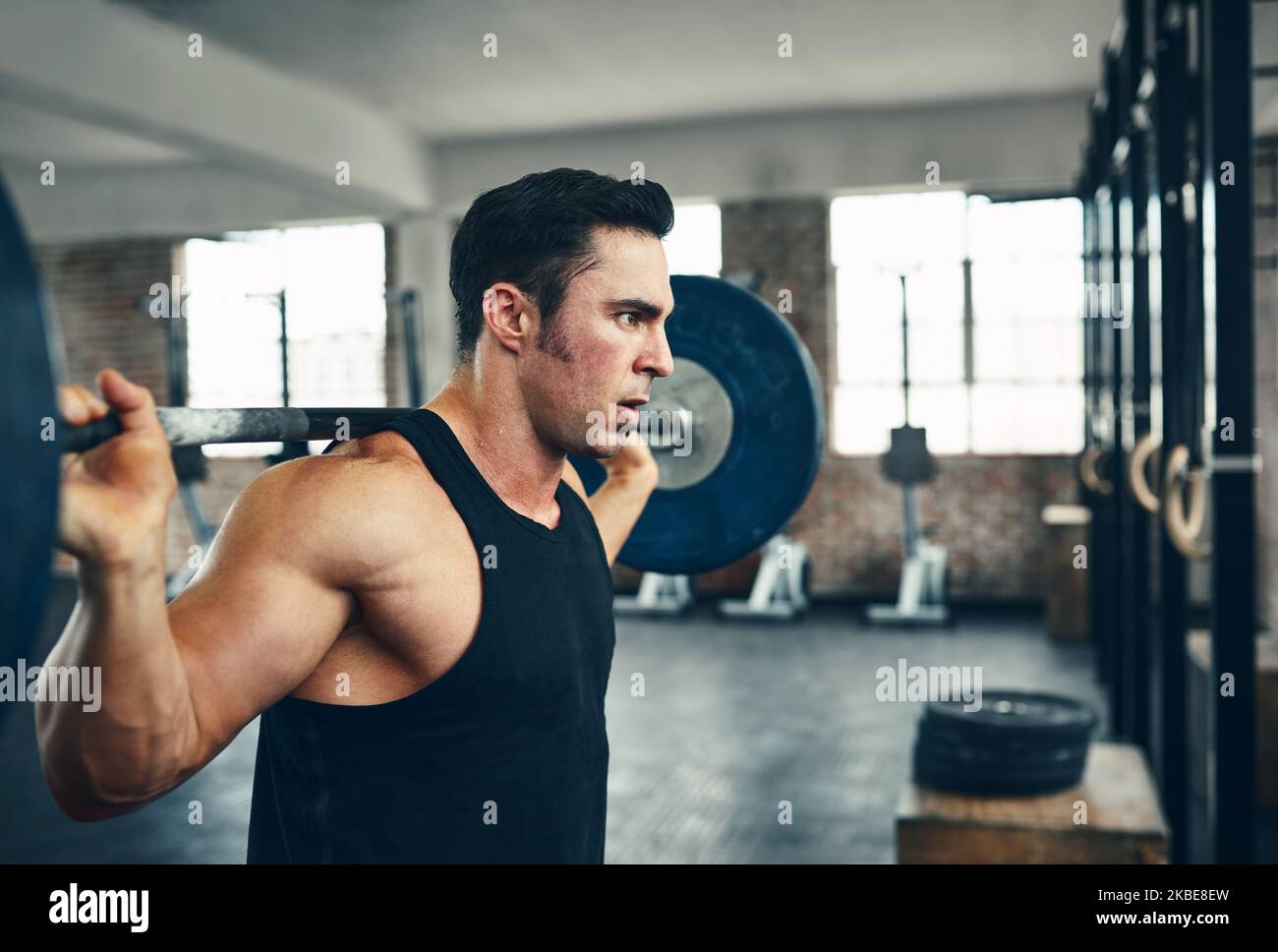 Focused on his fitness goals. a man lifting weights at the gym Stock ...