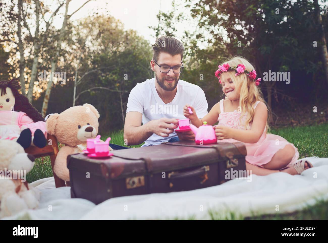 Time for tea. a cheerful daughter and father having a tea party with a ...