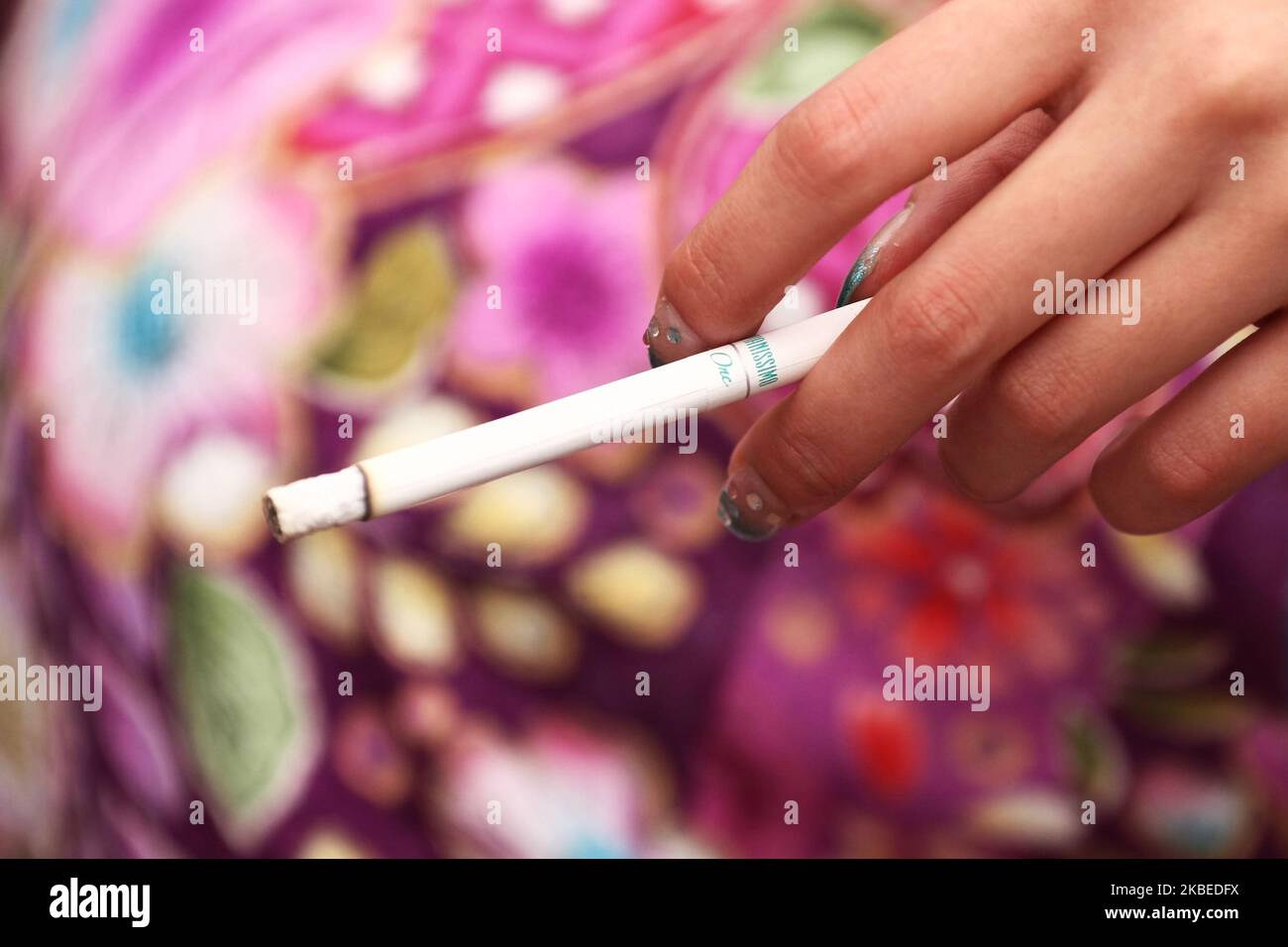 A Japanese woman smokes a cigarette at a ceremony celebrating the ...