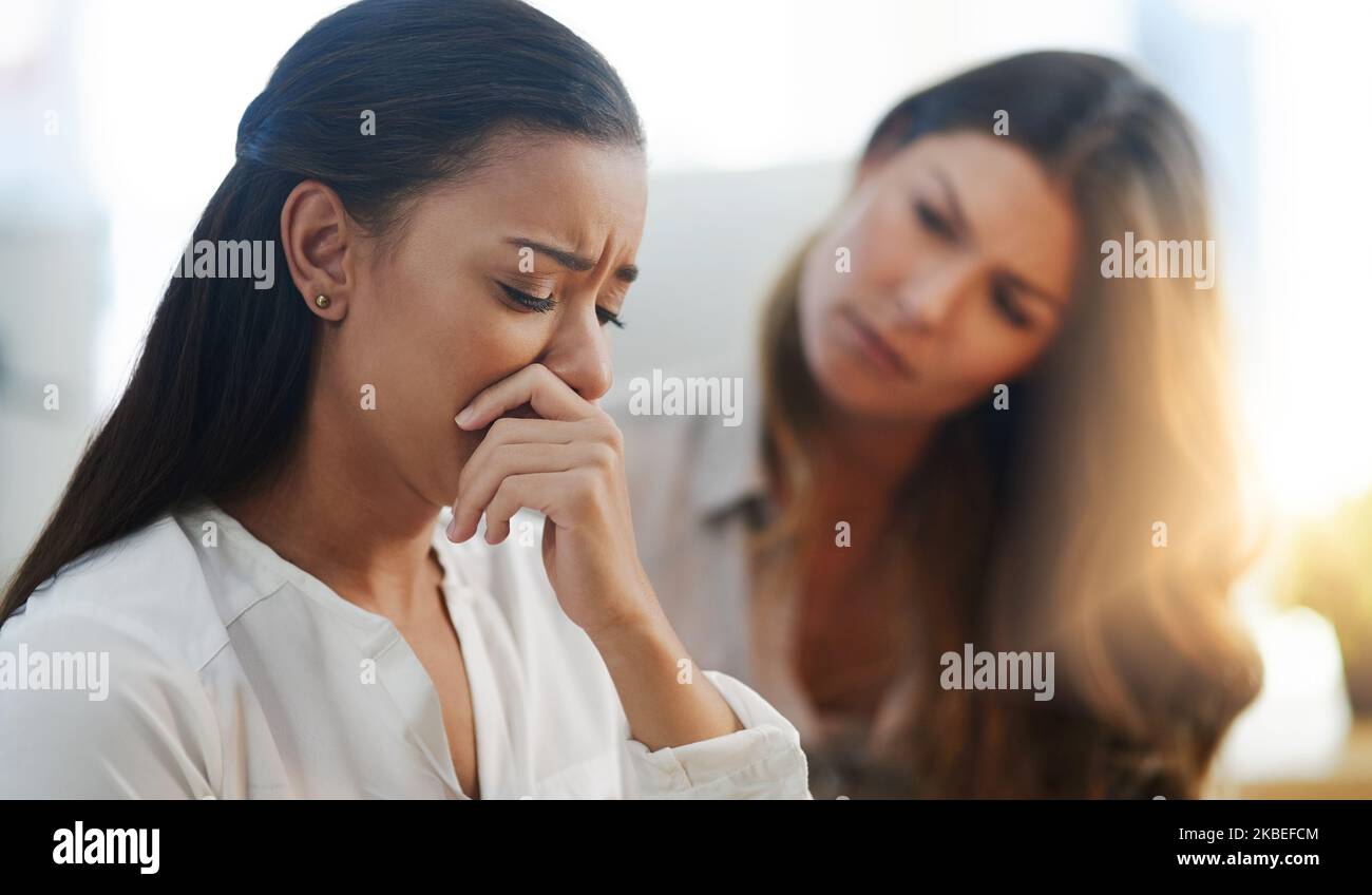 It was a hard decision. two young businesswomen talking to each other ...