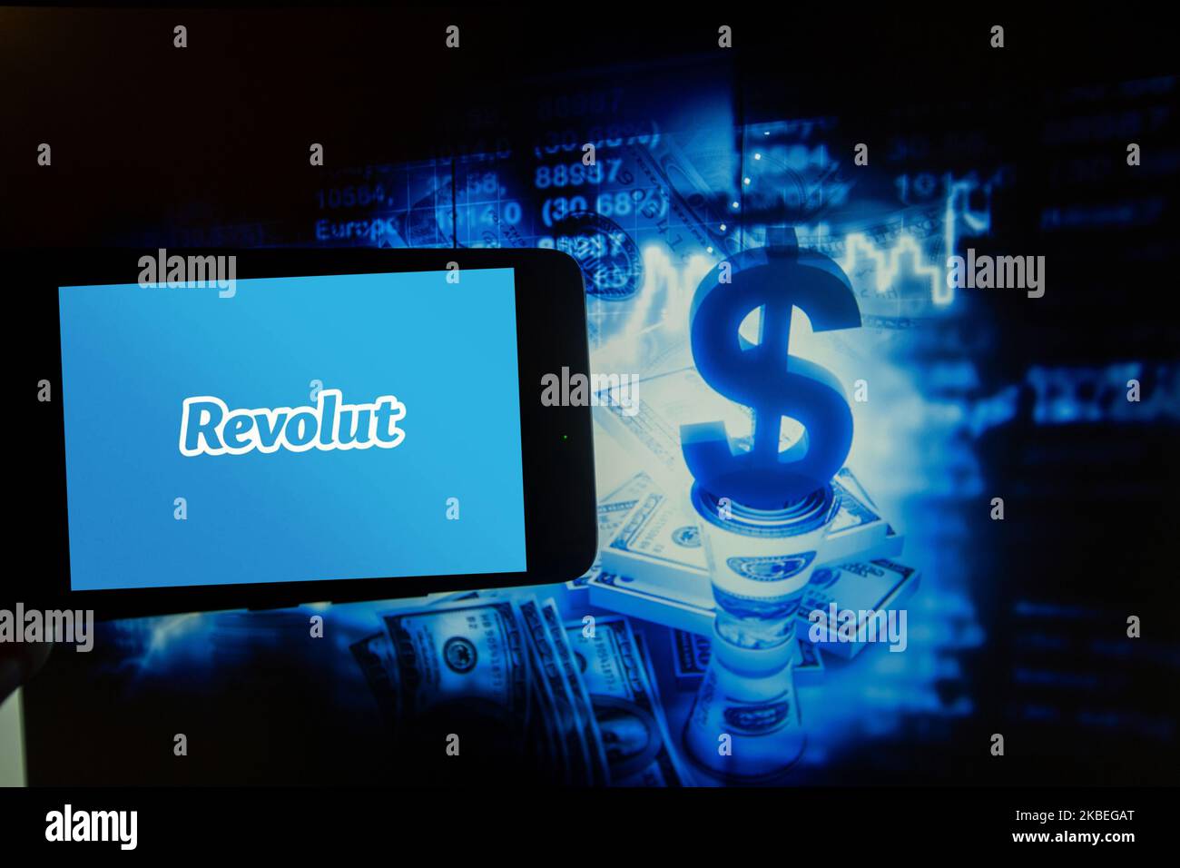 The logo of Revolut is seen on a screen of a smartphone next to an ...