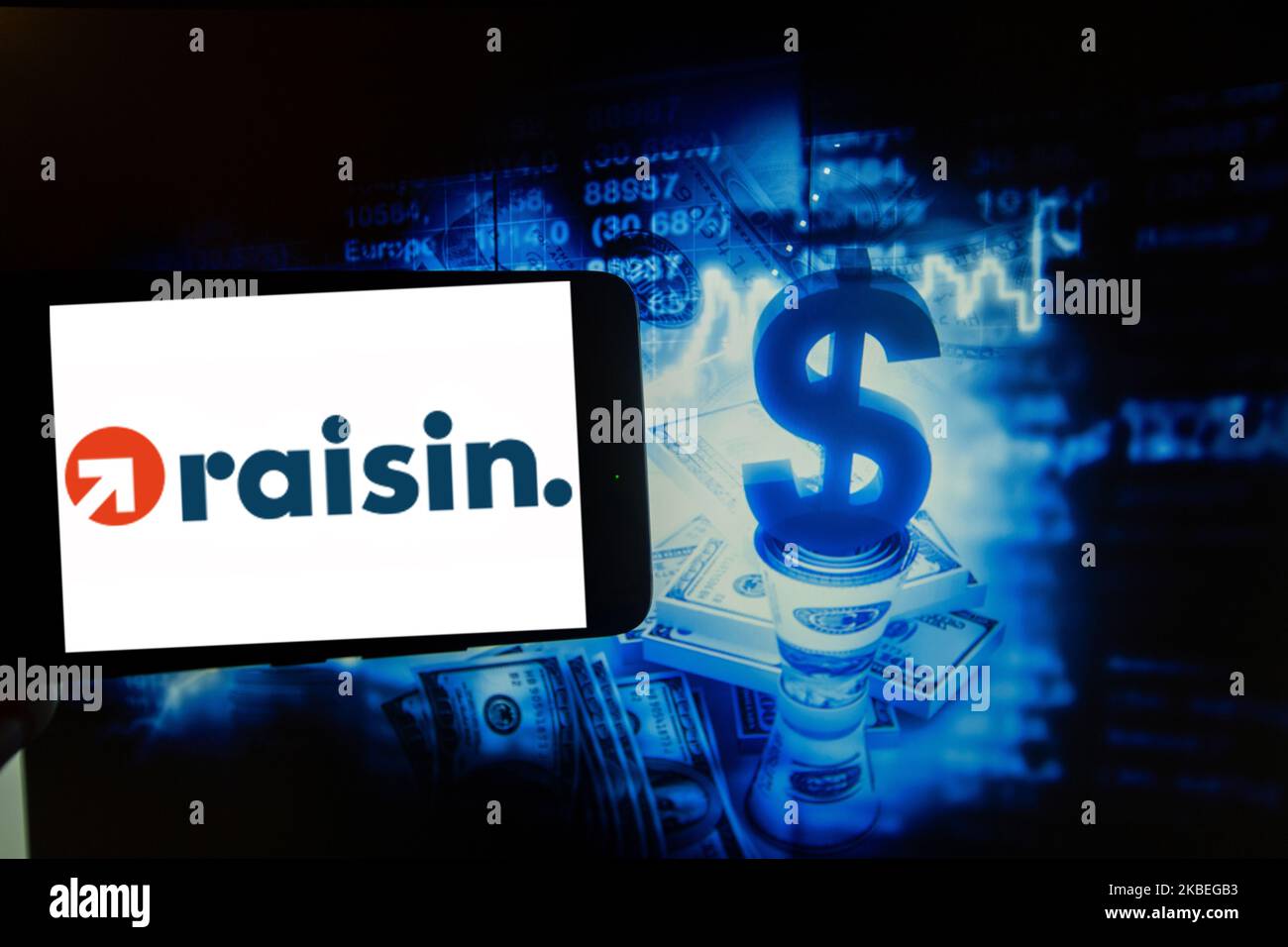The logo of Raisin Bank is seen on a screen of a smartphone next to an ...
