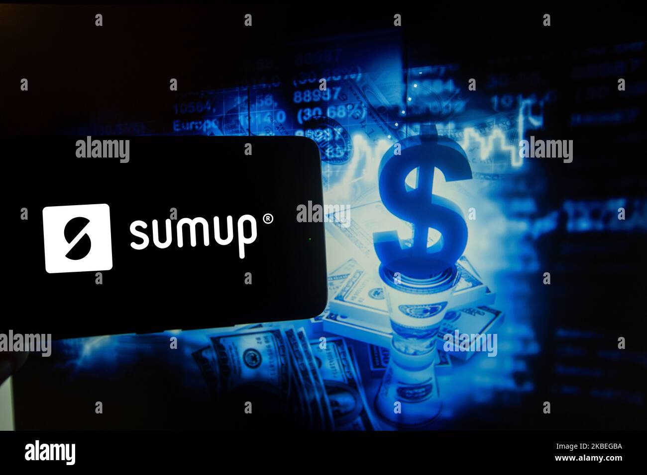 The logo of SumUp is seen on a screen of a smartphone next to an ...