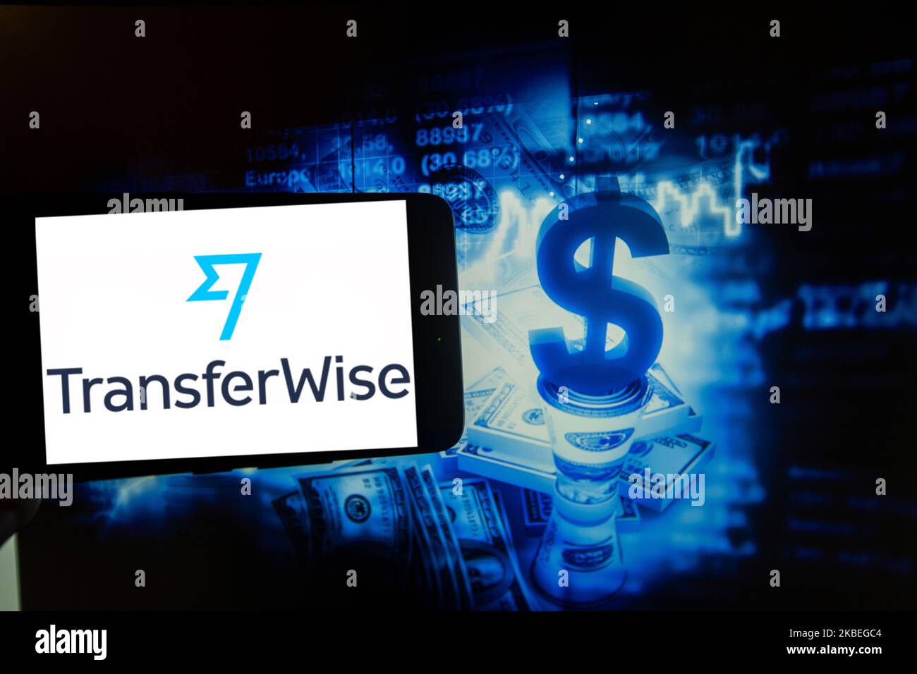 The logo of TransferWise is seen on a screen of a smartphone next to an ...