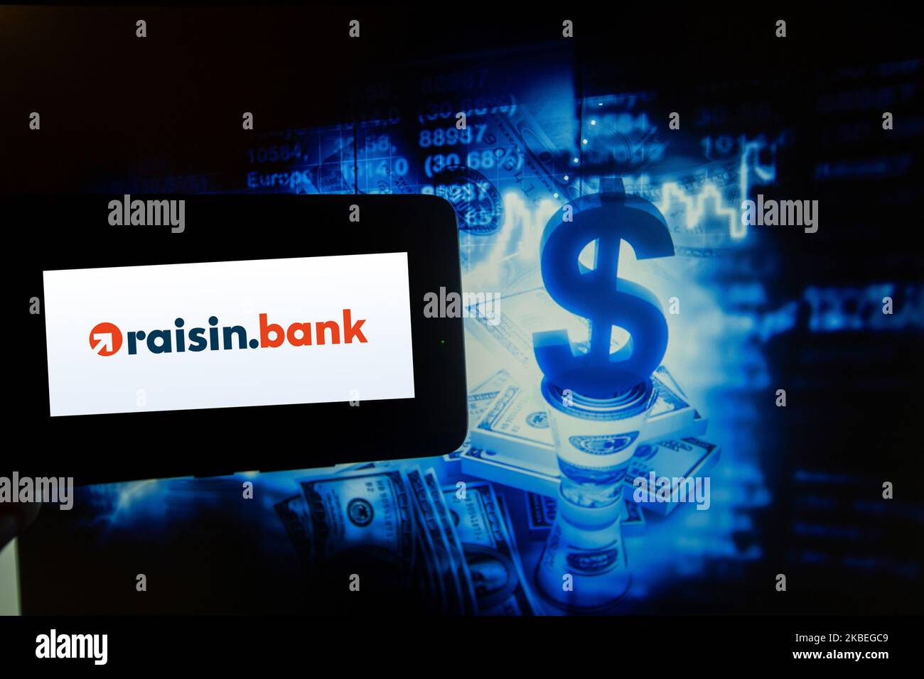 The logo of Raisin Bank is seen on a screen of a smartphone next to an ...