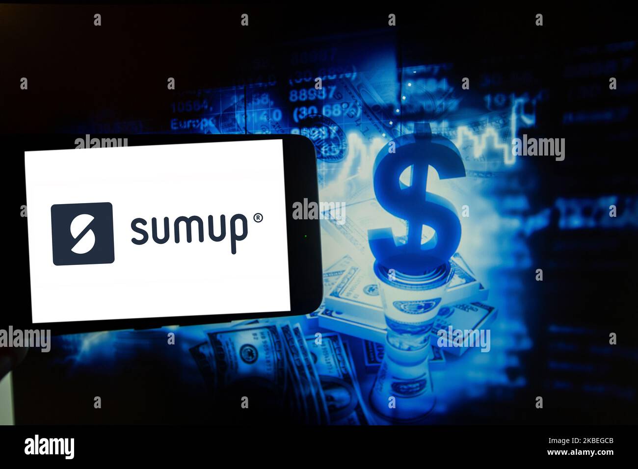 The logo of SumUp is seen on a screen of a smartphone next to an ...