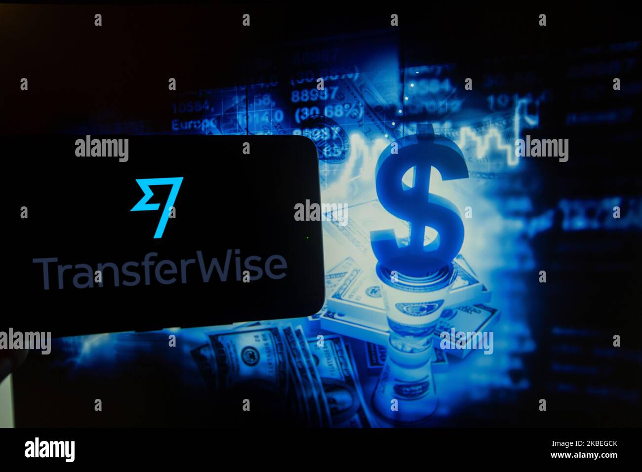 The logo of TransferWise is seen on a screen of a smartphone next to an ...