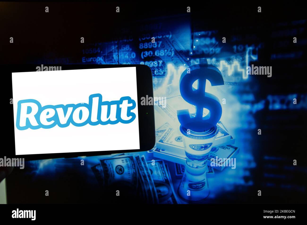 The logo of Revolut is seen on a screen of a smartphone next to an ...