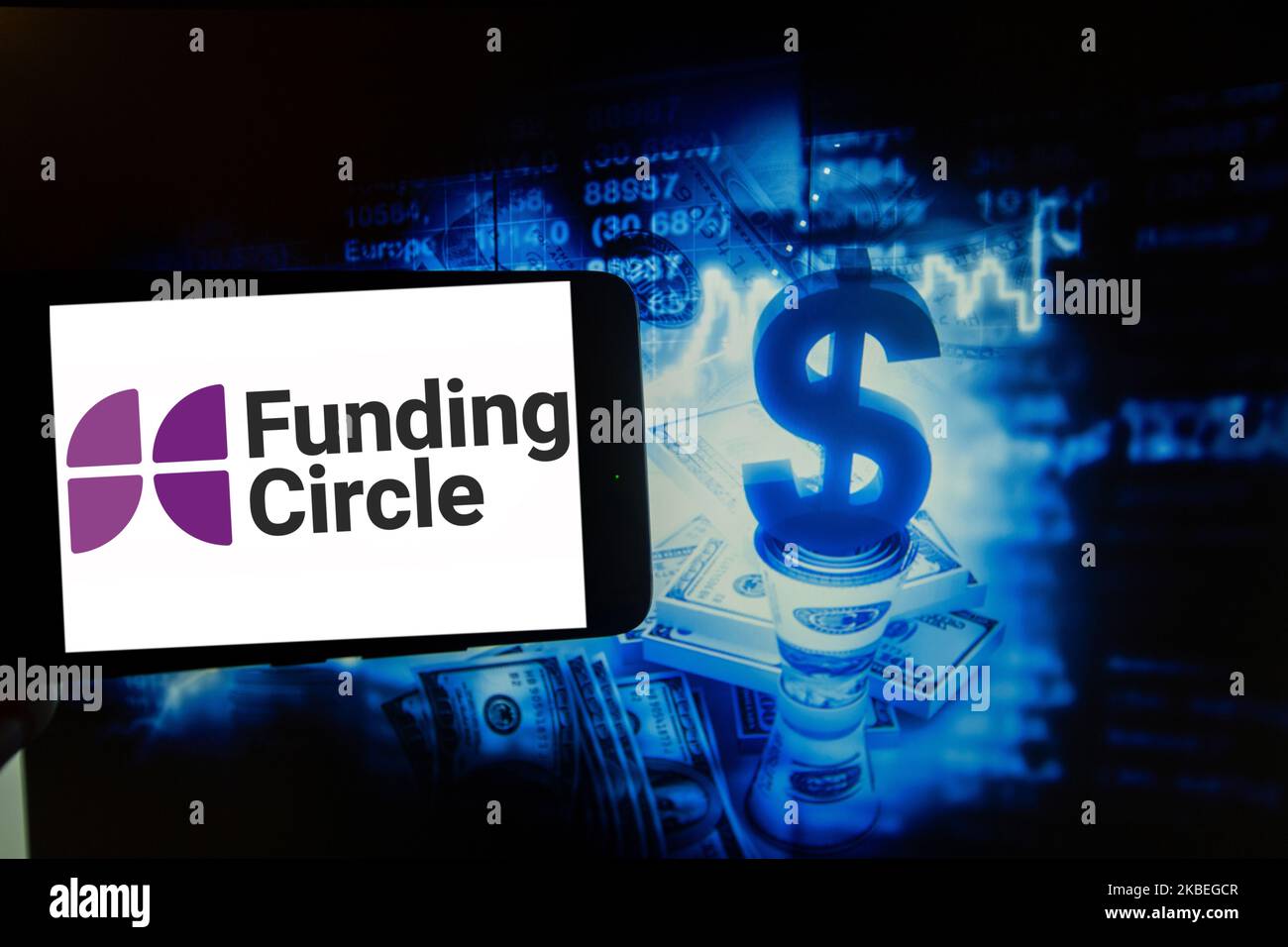 The logo of Funding Circle is seen on a screen of a smartphone next to ...