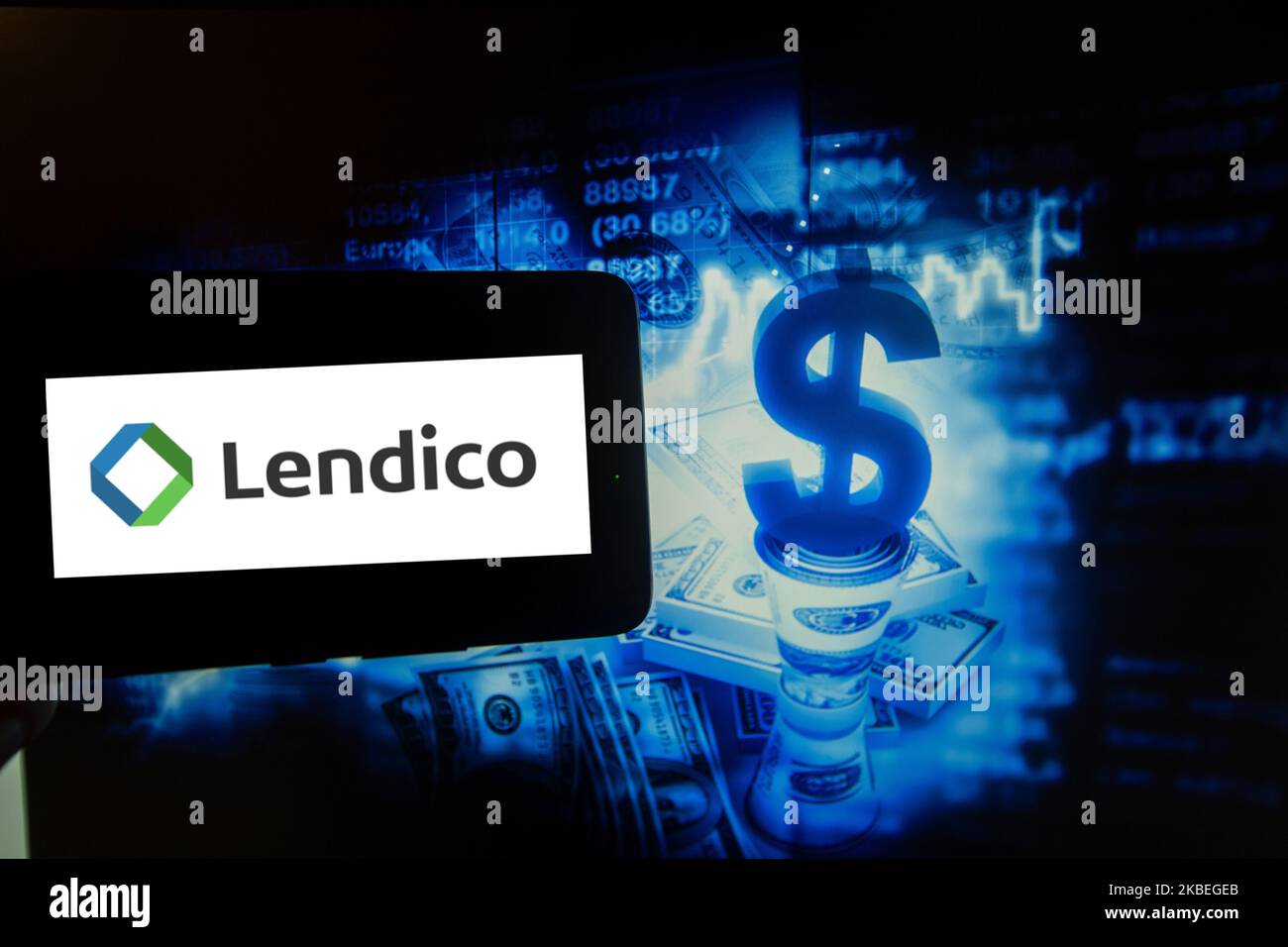 The logo of Lendico is seen on a screen of a smartphone next to an illustration of money and ...