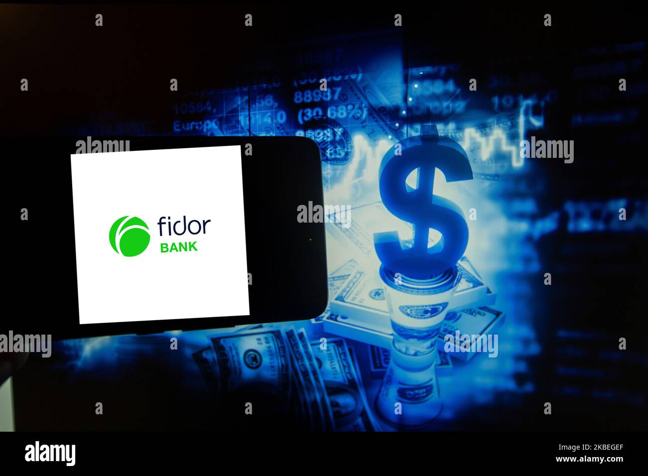 The logo of the Fidor Bank is seen on a screen of a smartphone next to ...