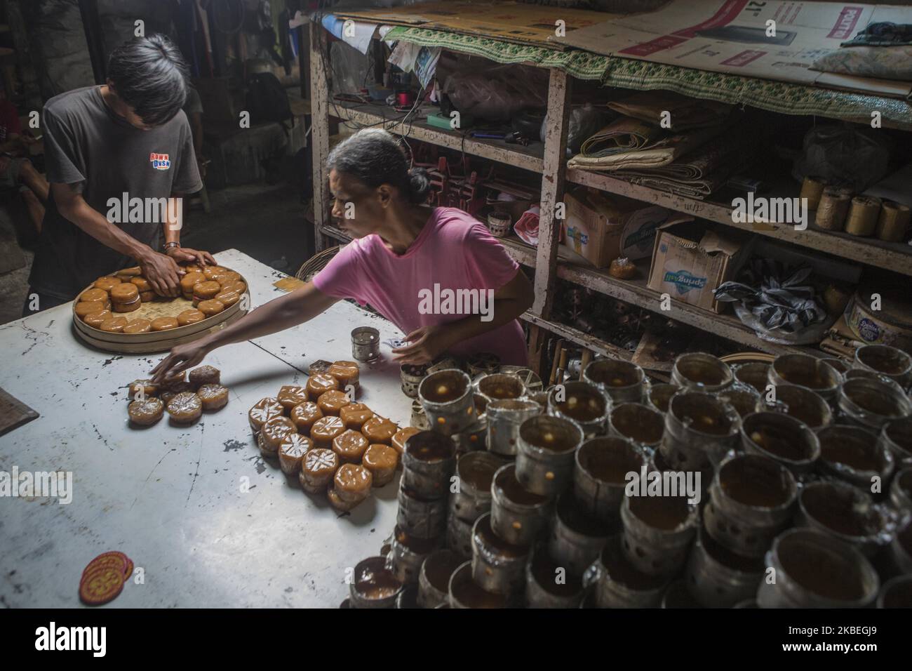 Workers making a traditional cake during a preparation to celebrate the ...