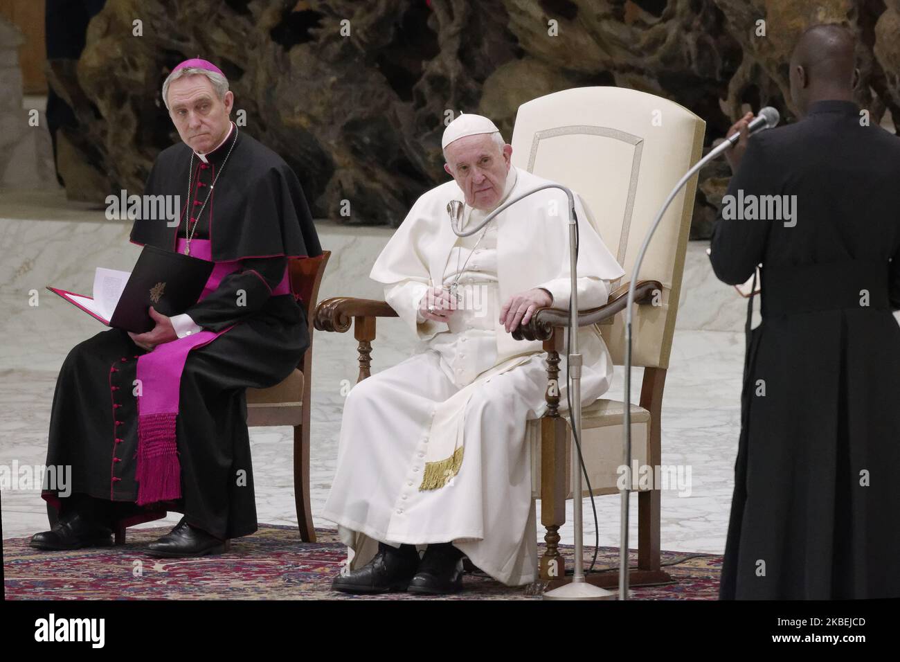Pope Francis is flanked by Papal Household Archbishop Georg Gaenswein ...