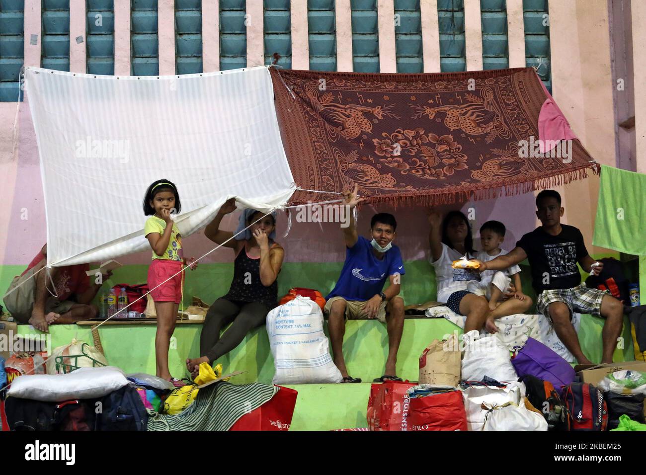 Evacuees take shelter in an temporary evacuation center in Batangas ...