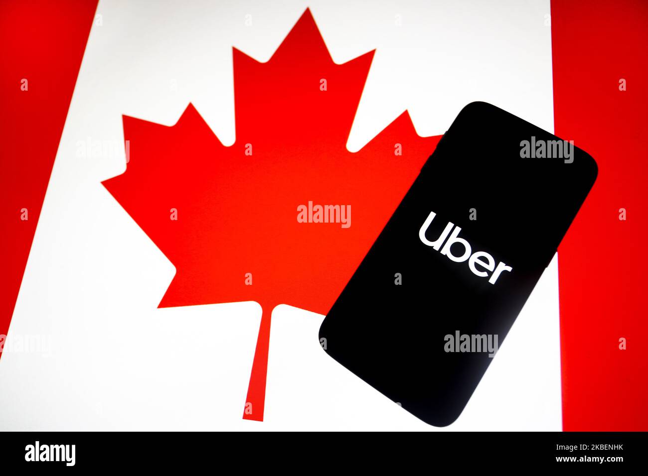 Uber logo is displayed on a mobile phone screen photographed on Cabada ...