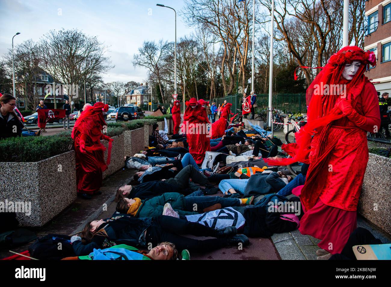 XR activists and the Red Rebel Brigade are performing a Die-In action ...
